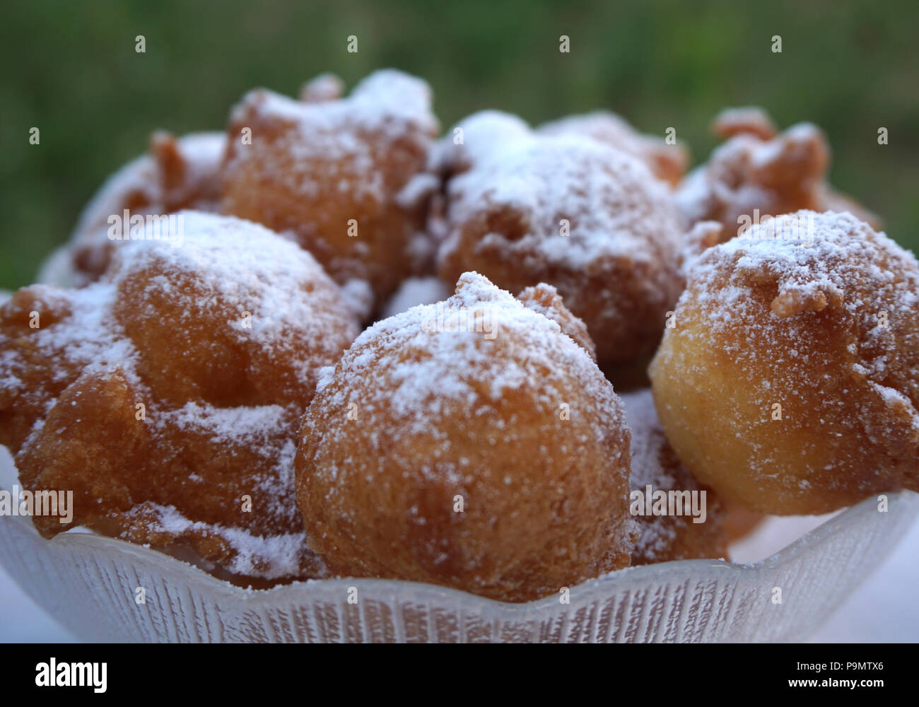 Homemade fritters balls, Croatian fritule, in glass bowl, with powdered ...