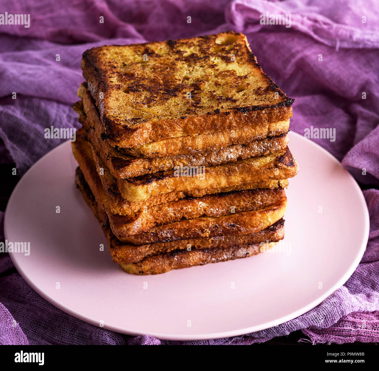 Fried square pieces of white wheat flour in a ceramic pink plate, close ...