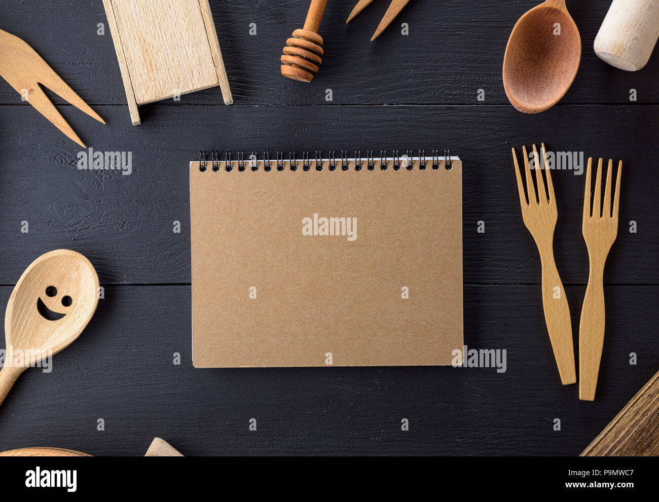open notebook with blank pages in the middle of wooden kitchen items on ...