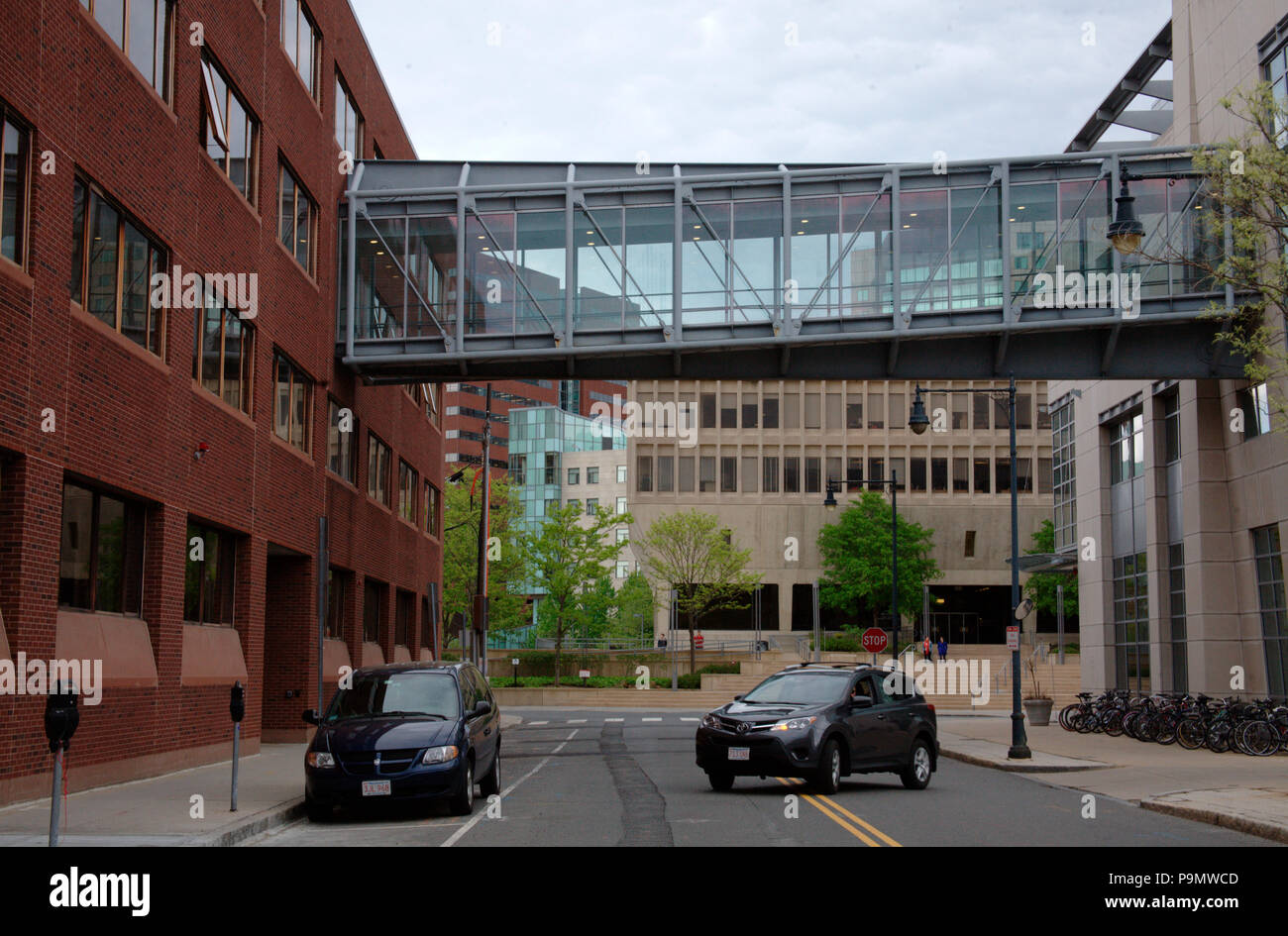 Two building joined with glass corridor Stock Photo - Alamy