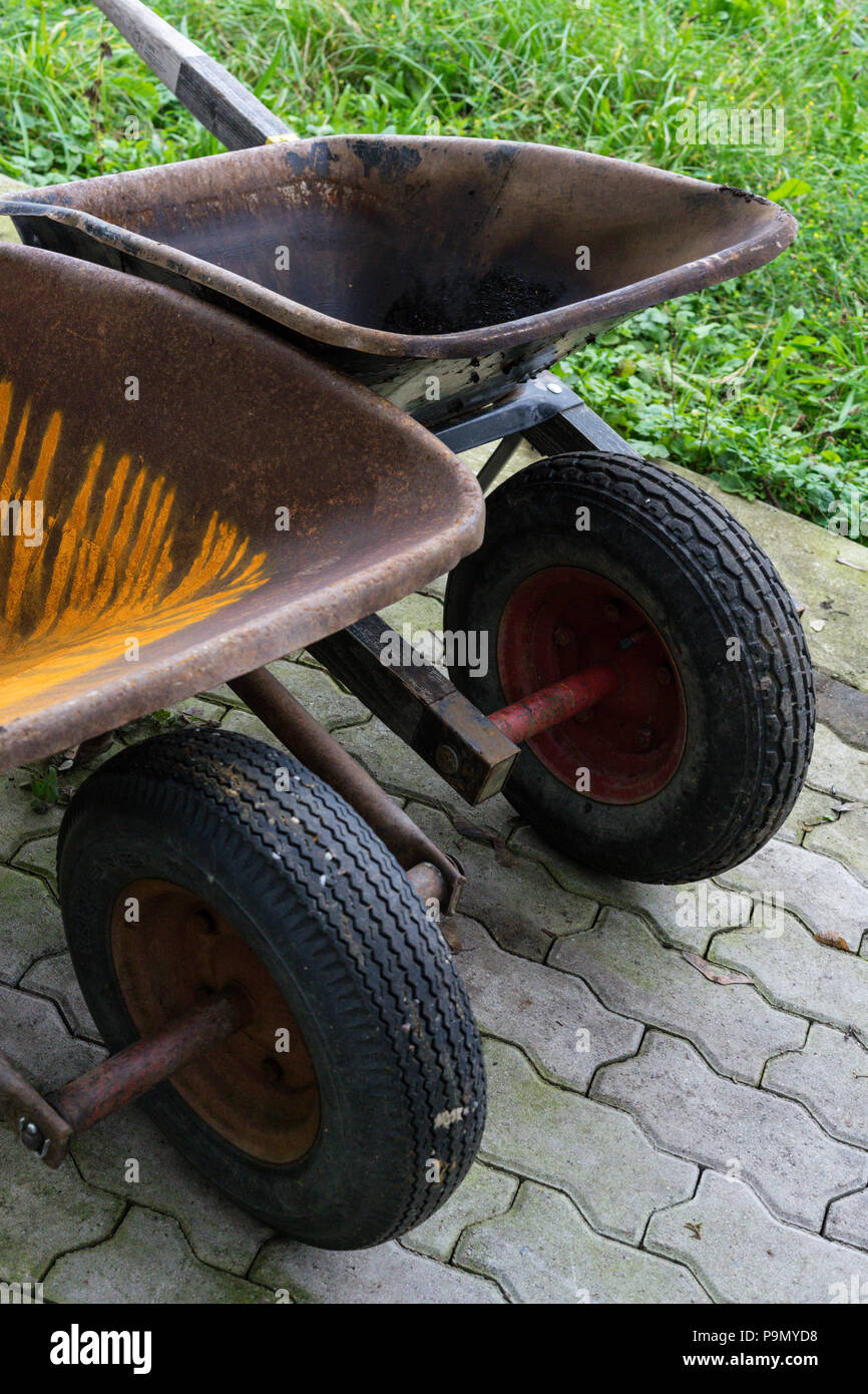 empty wheelbarrow for gardening and construction work with yellow paint ...