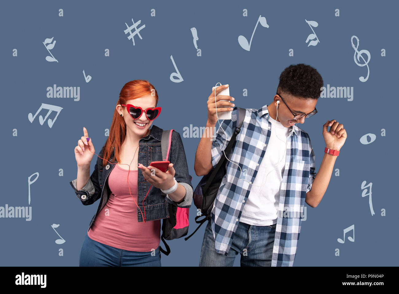 Relaxed students listening to music and dancing joyfully Stock Photo ...