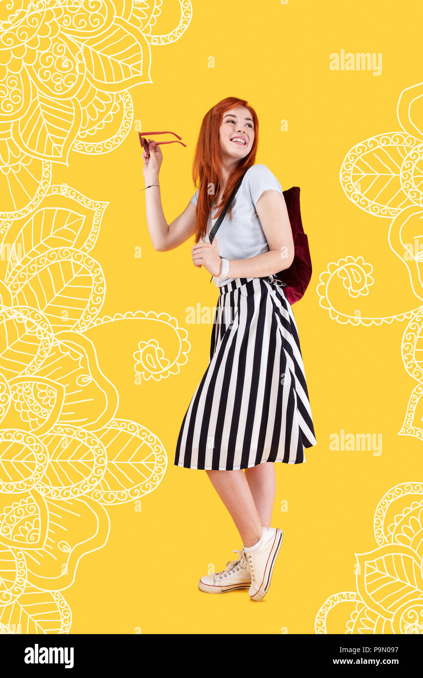 Relaxed student smiling while taking a stroll alone Stock Photo - Alamy