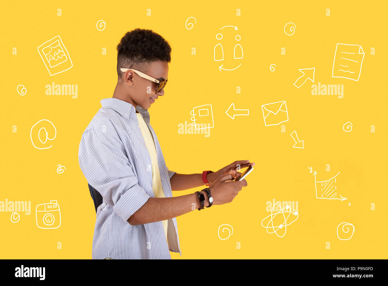Positive teenager typing messages and smiling Stock Photo - Alamy