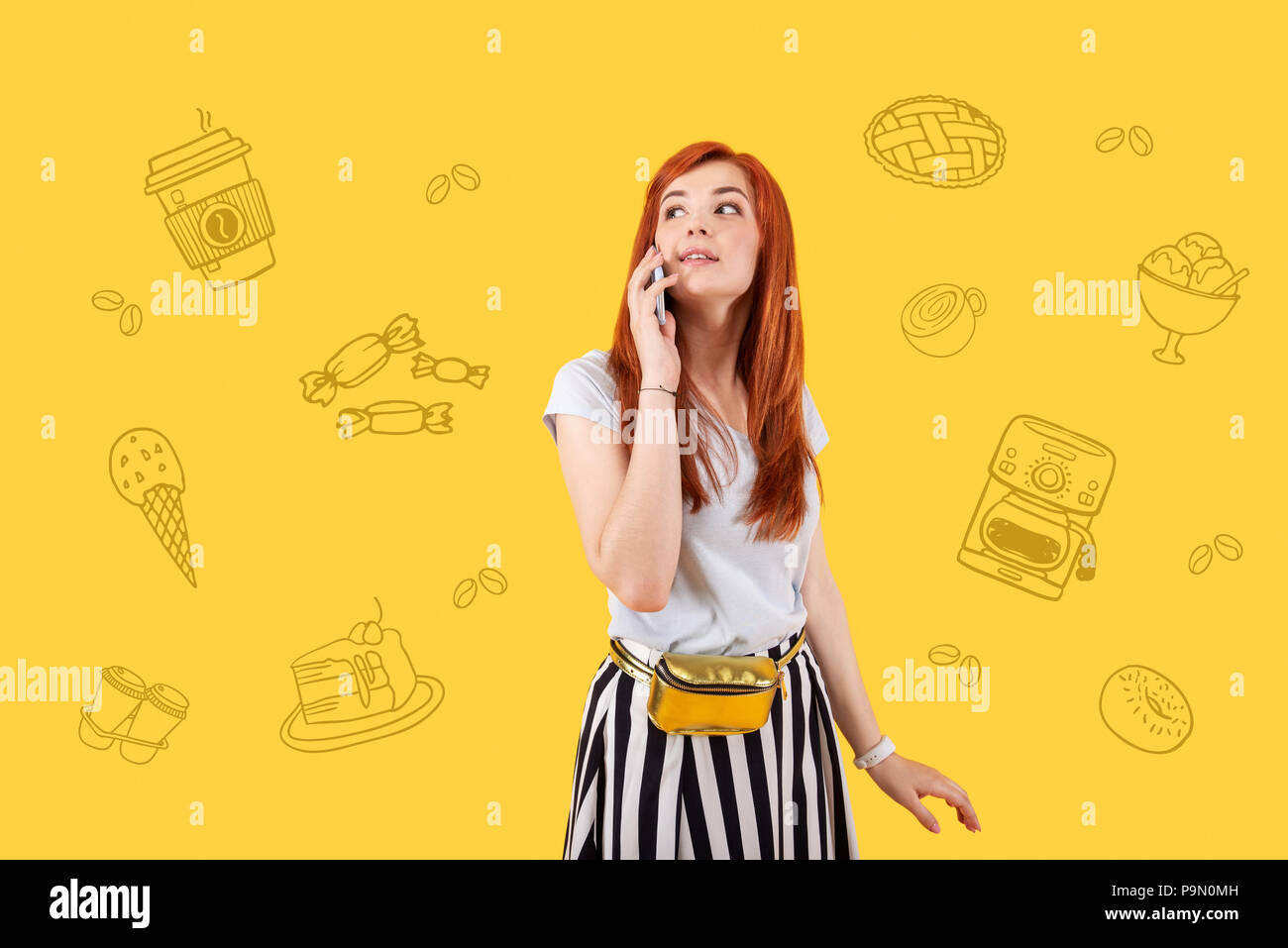 Cute girl talking on the phone and feeling hungry Stock Photo - Alamy