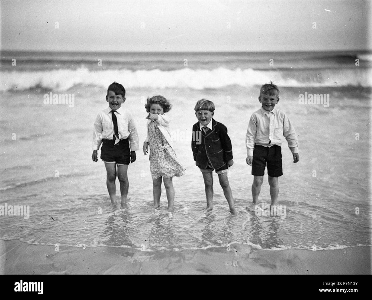 298 SLNSW 9899 Four young children paddling fully clothed Stock Photo ...
