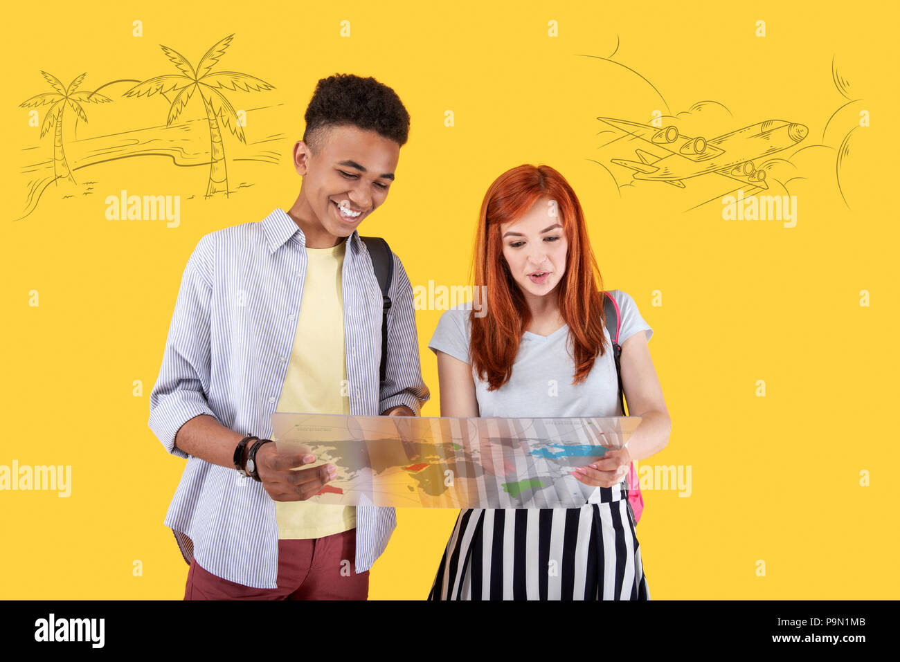 Curious tourists smiling and looking attentively at the map Stock Photo ...