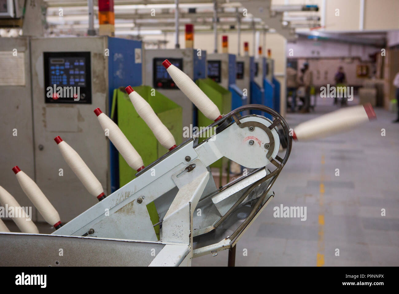 Organic cotton being spun at a garment factory, where organic cotton is ...