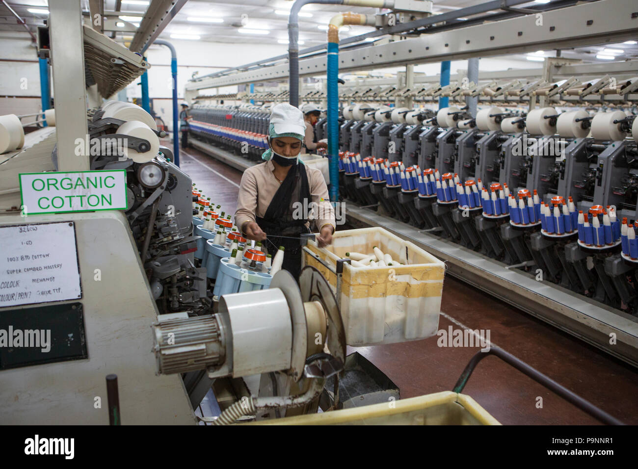 Organic cotton being spun at a garment factory, where organic cotton is ...