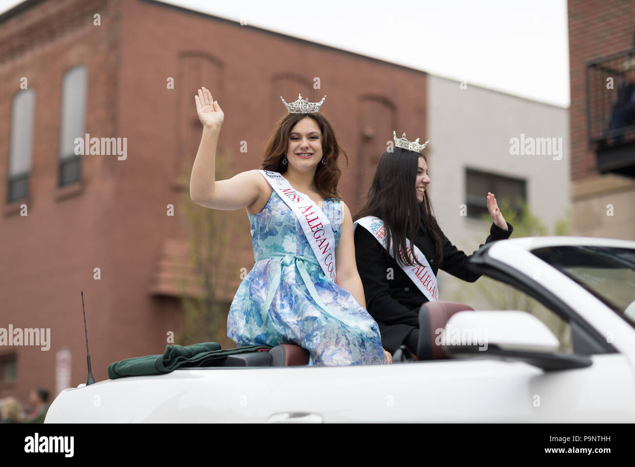 Holland, Michigan, USA - May 12, 2018 A beauty queen smiles and waves ...