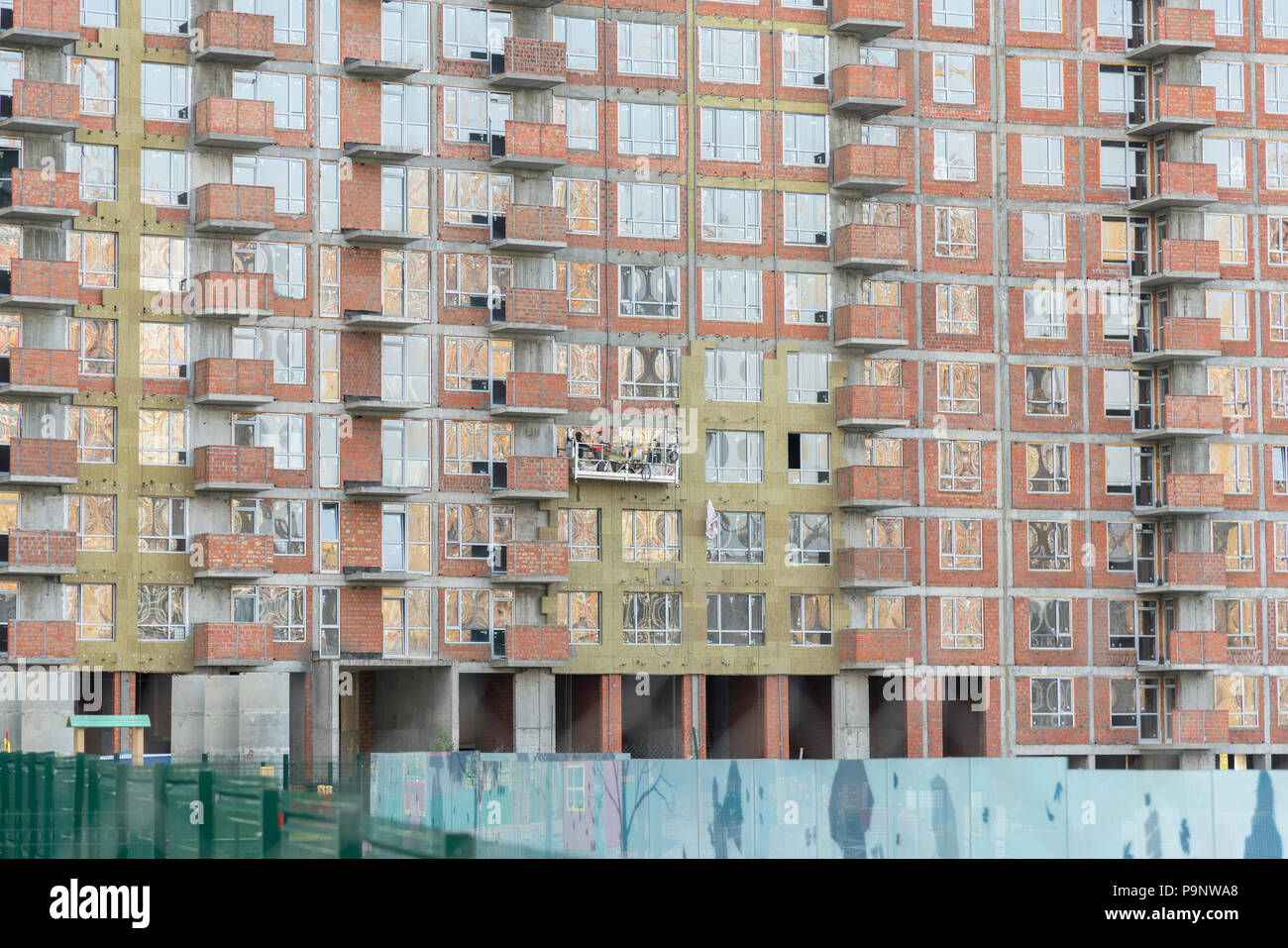 The process of warming a multi-storey building. Workers warm a multi ...