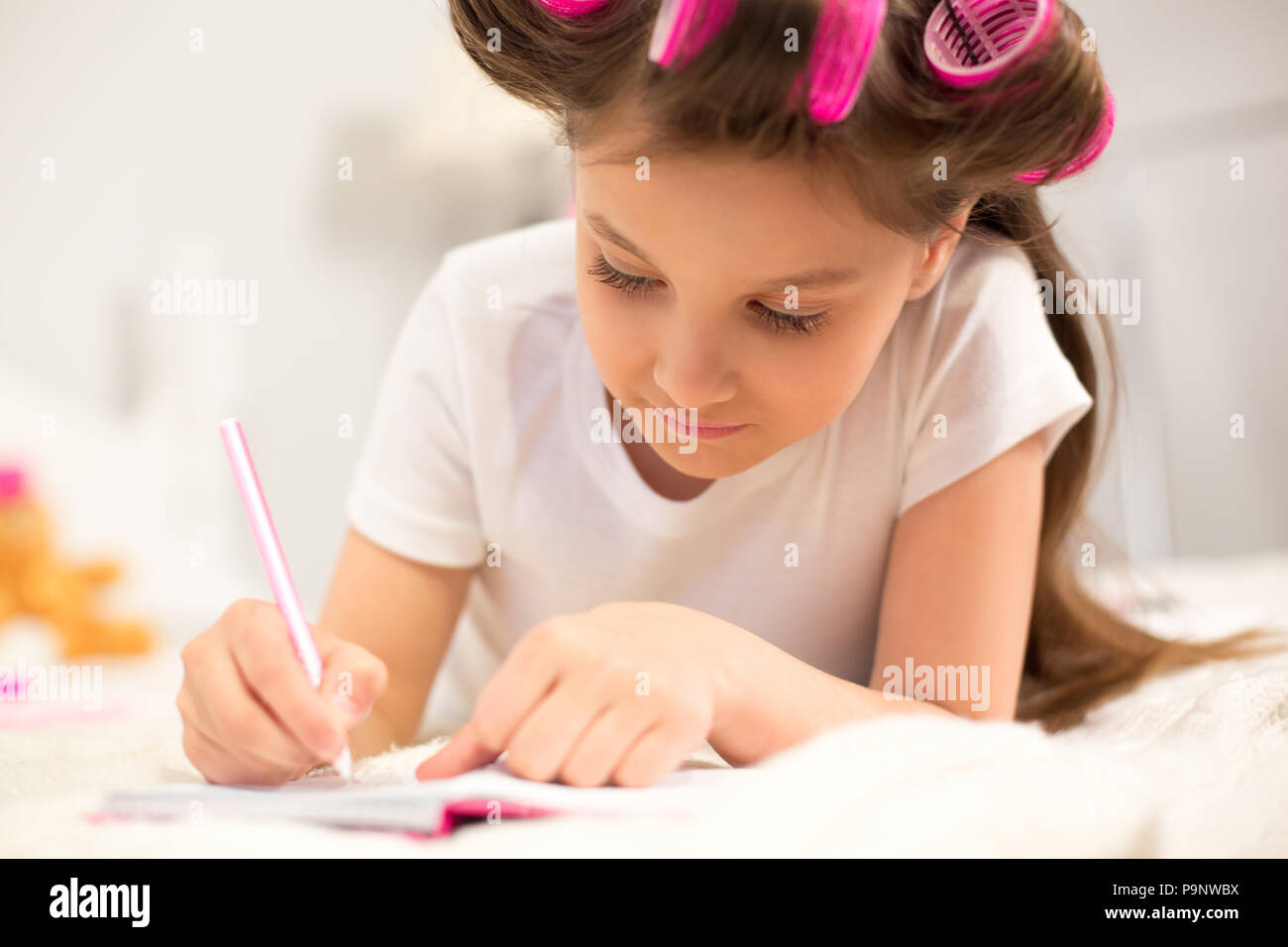 Girl writing in her notebook in bed Stock Photo - Alamy