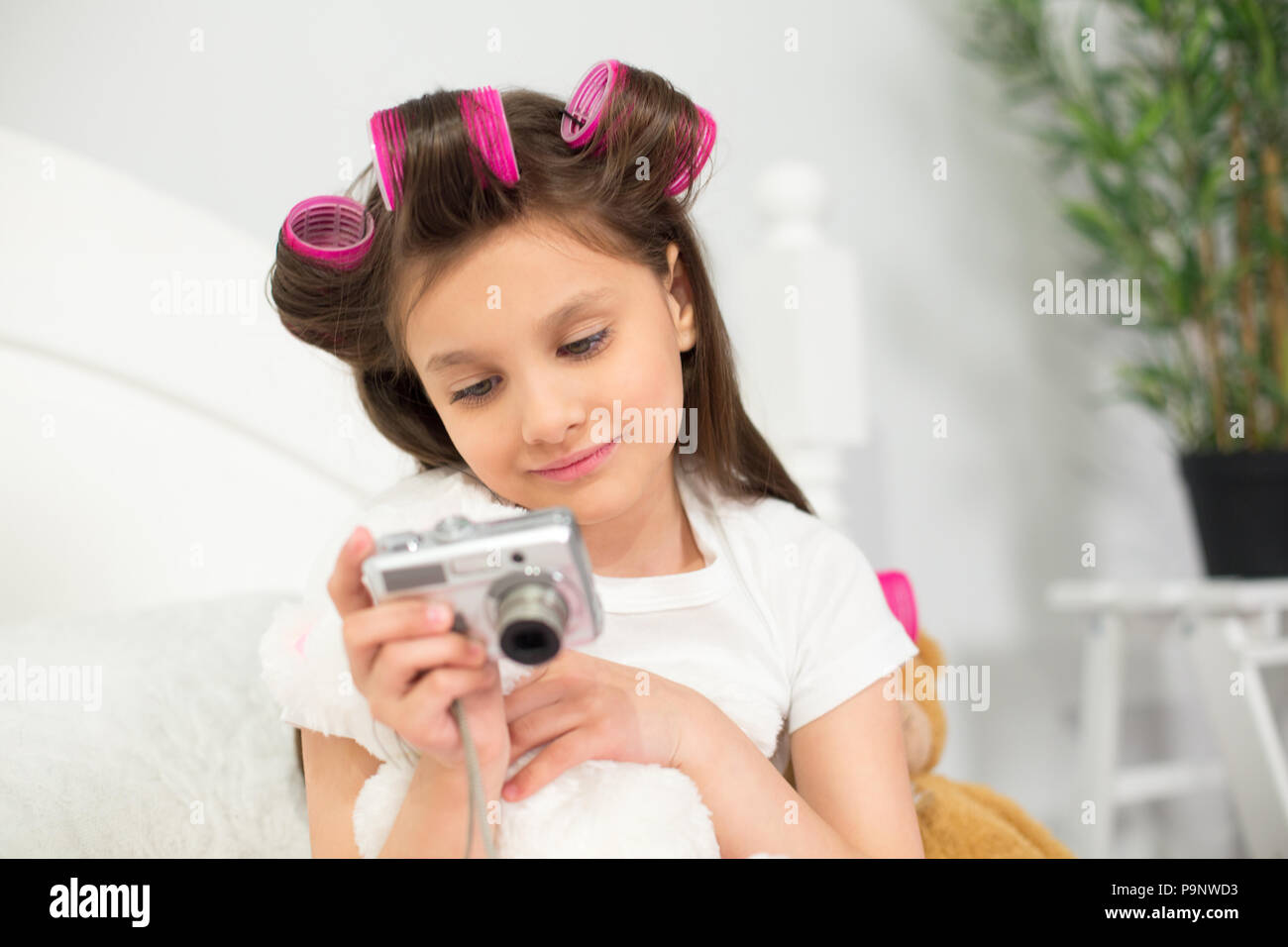 Girl playing with camera Stock Photo - Alamy