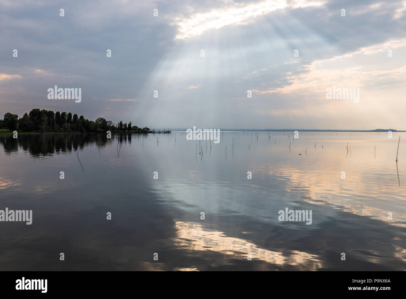 Perfectly symmetric and spectacular view of a lake, with clouds, sky ...