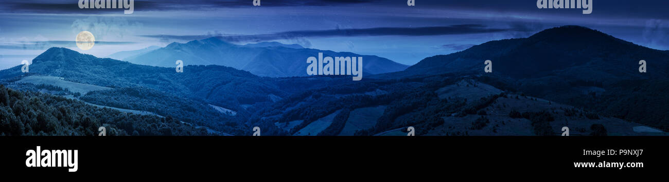 panorama of beautiful mountain ridge at night in full moon light ...