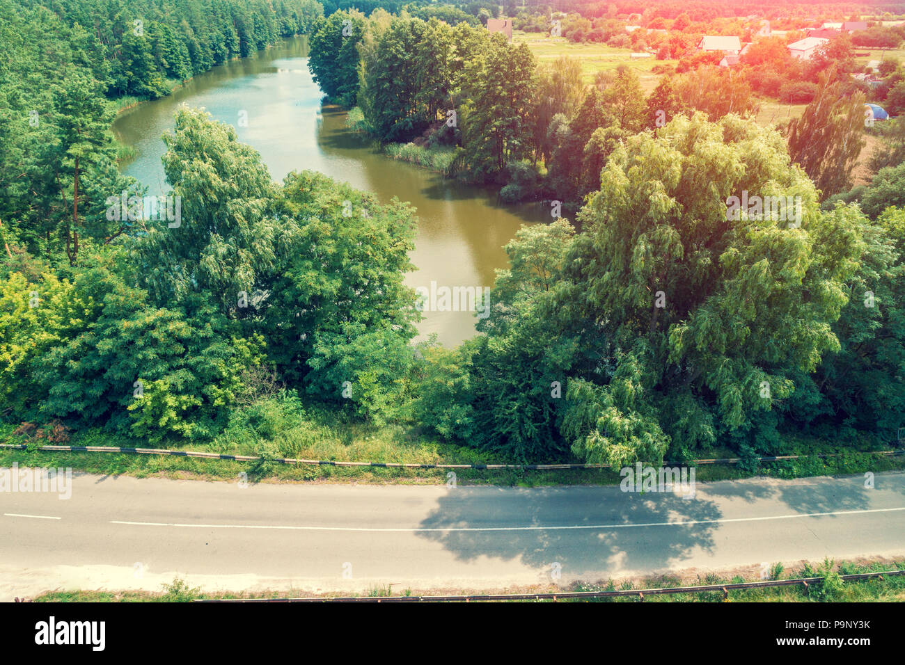Aerial view of lake with beautiful reflection of clouds. Forest along ...