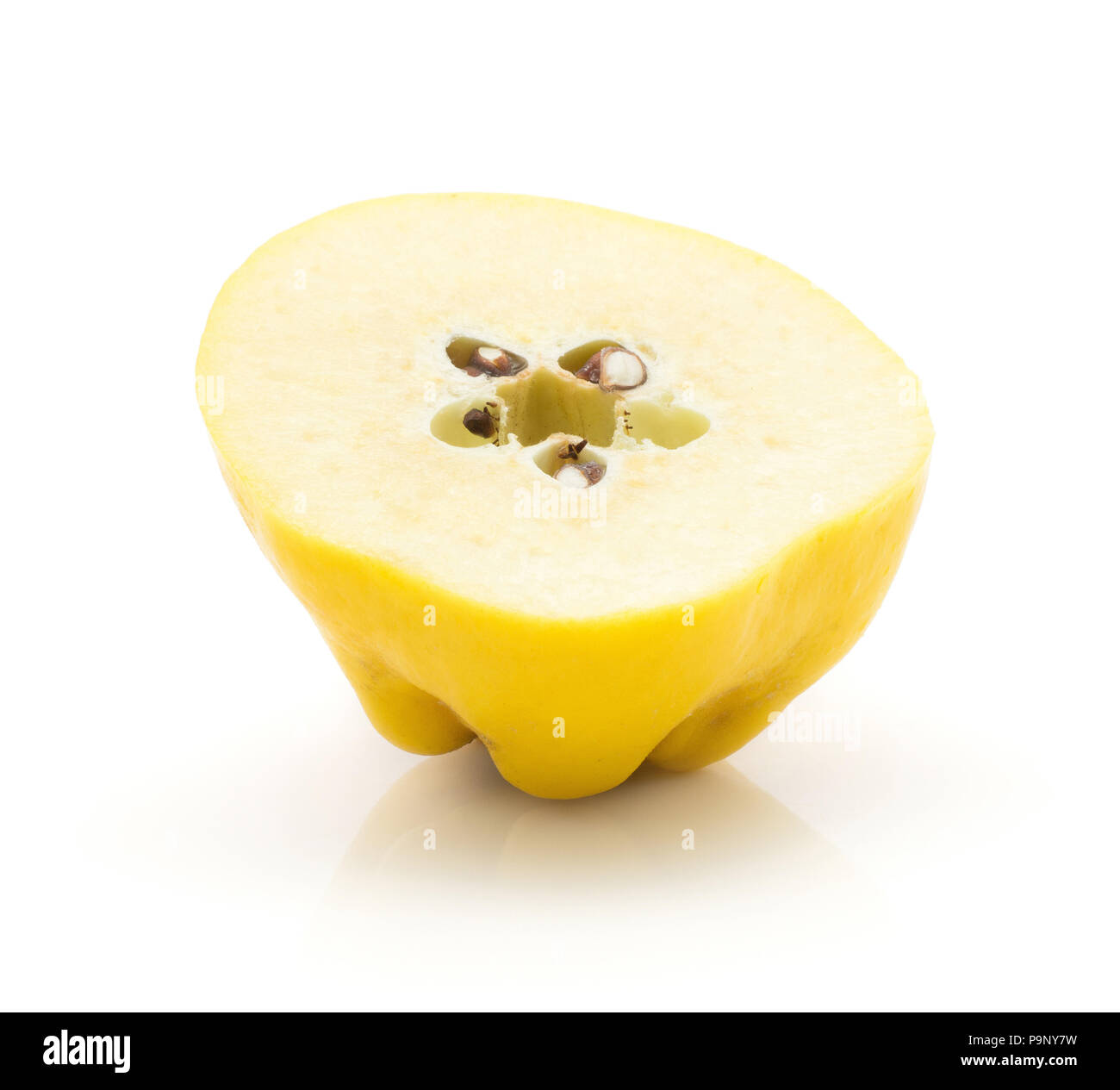 One quince half isolated on white background raw yellow with seeds ...