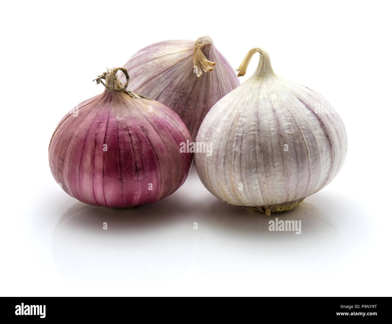 Three whole solo pearl garlic isolated on white background single clove ...
