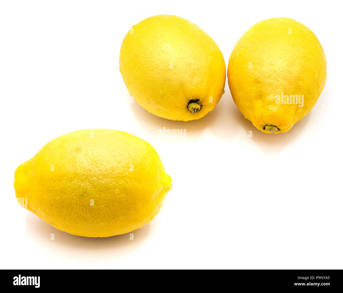 Three yellow lemons isolated on white background Stock Photo - Alamy