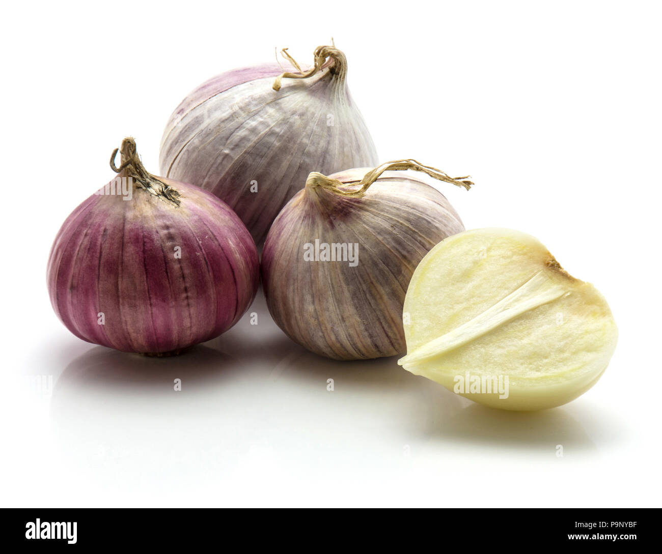 Solo garlic isolated on white background three whole bulbs and one half ...