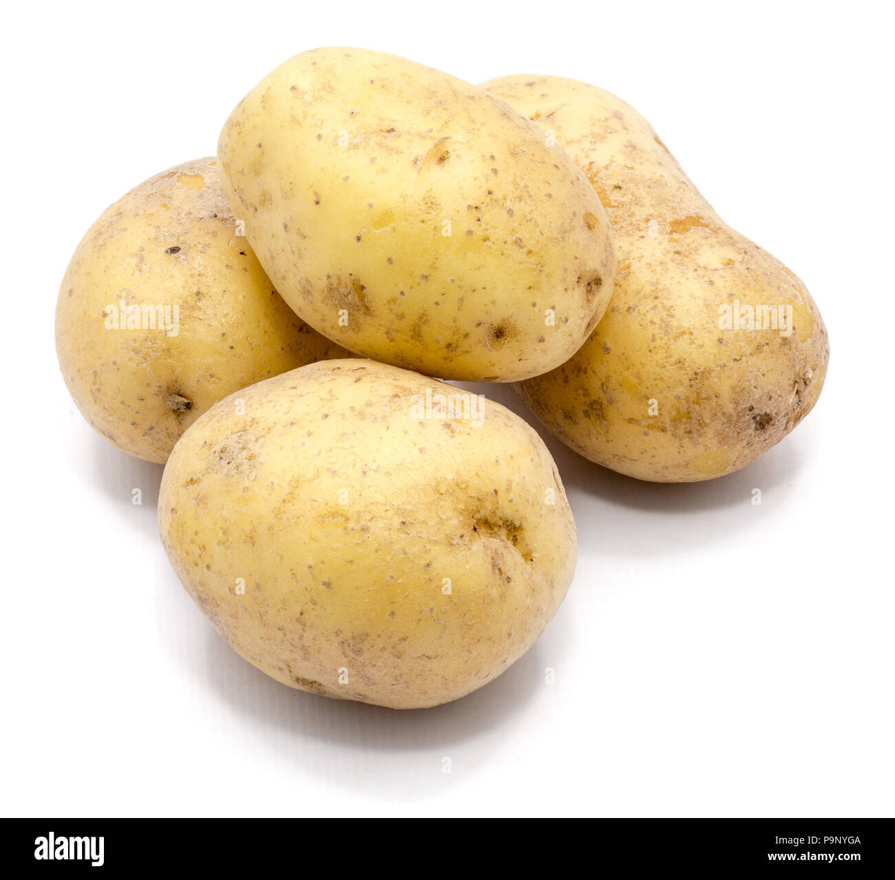 Four whole potatoes isolated on white background Stock Photo - Alamy