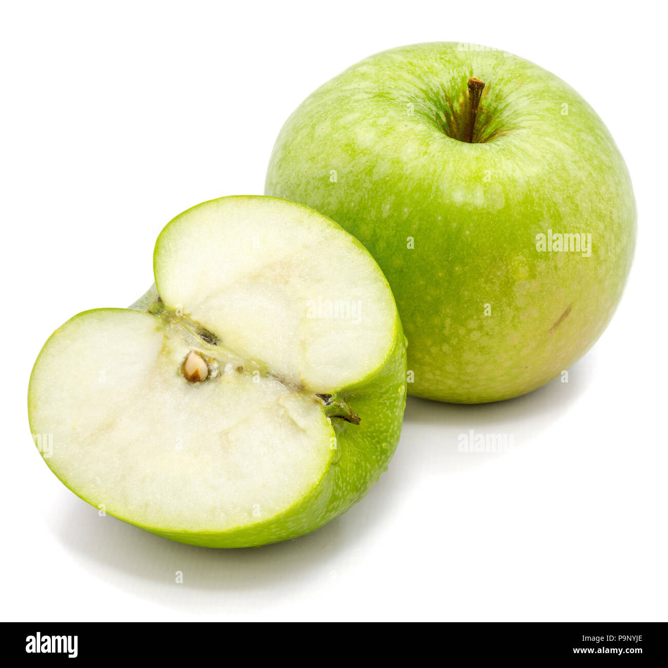 One whole apple Granny Smith and a half isolated on white background ...