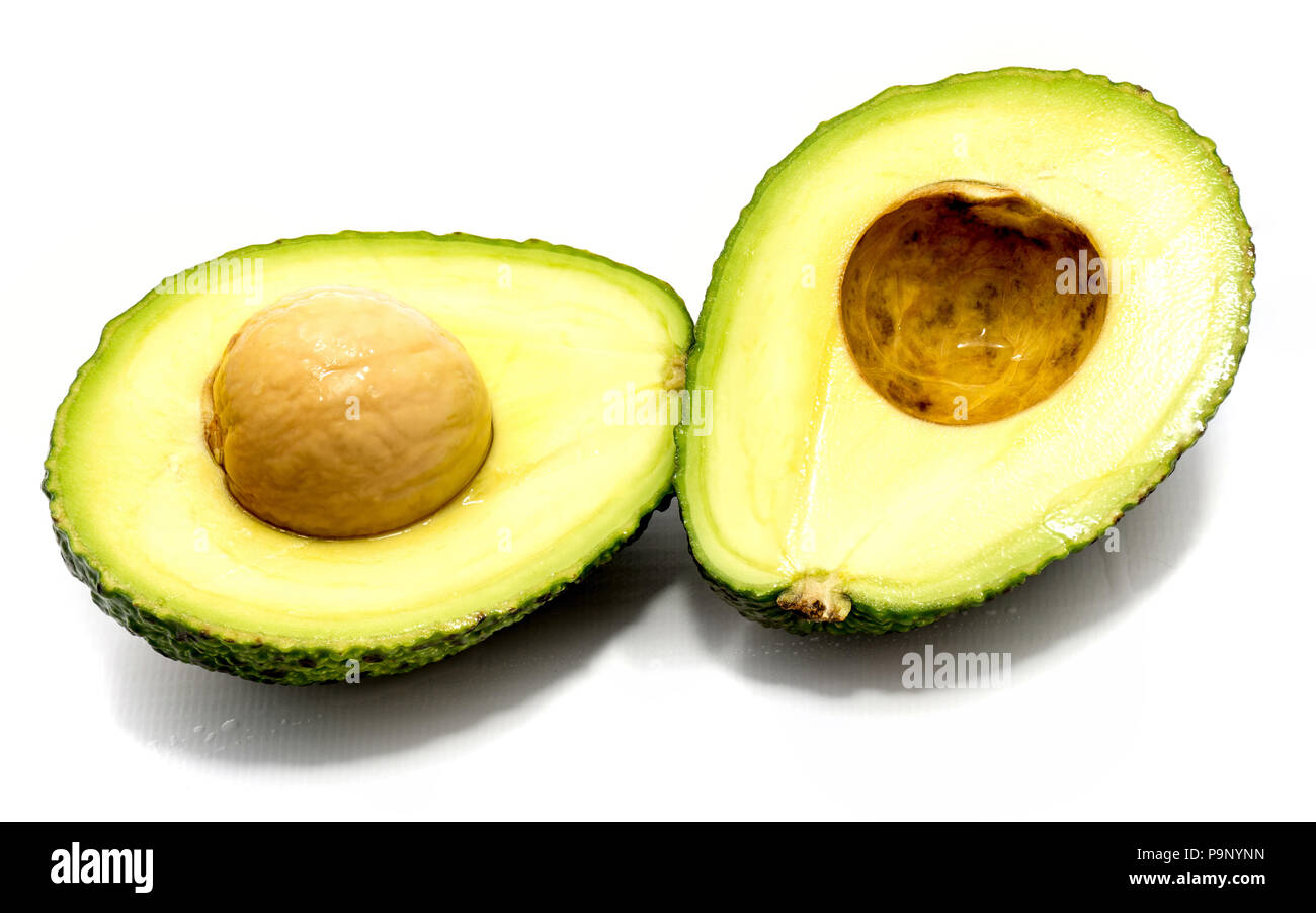 Sliced avocado (Persea americana, alligator pear) with a stone isolated ...