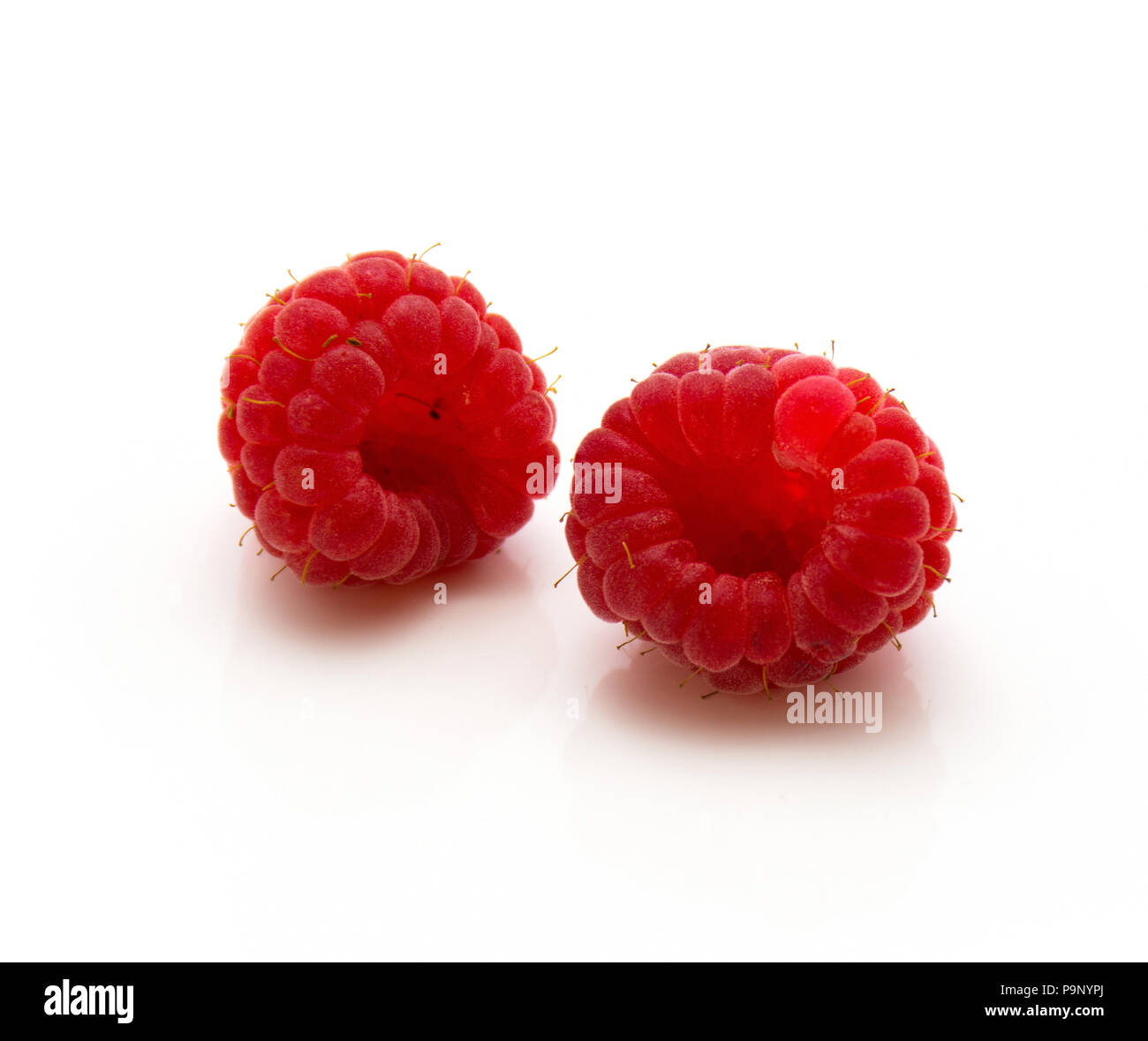 Two red raspberries isolated on white background Stock Photo - Alamy