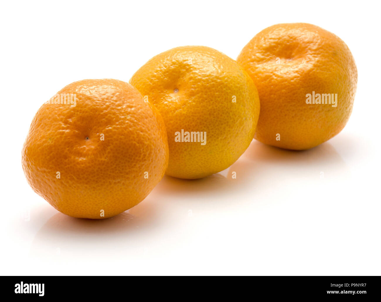 Three tangerines in row isolated on white background Stock Photo - Alamy