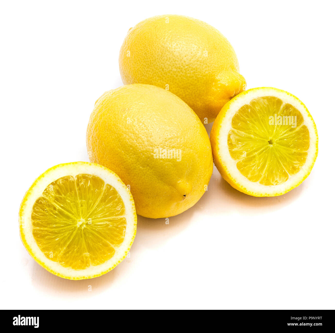 Two whole yellow lemons and two halves isolated on white background ...