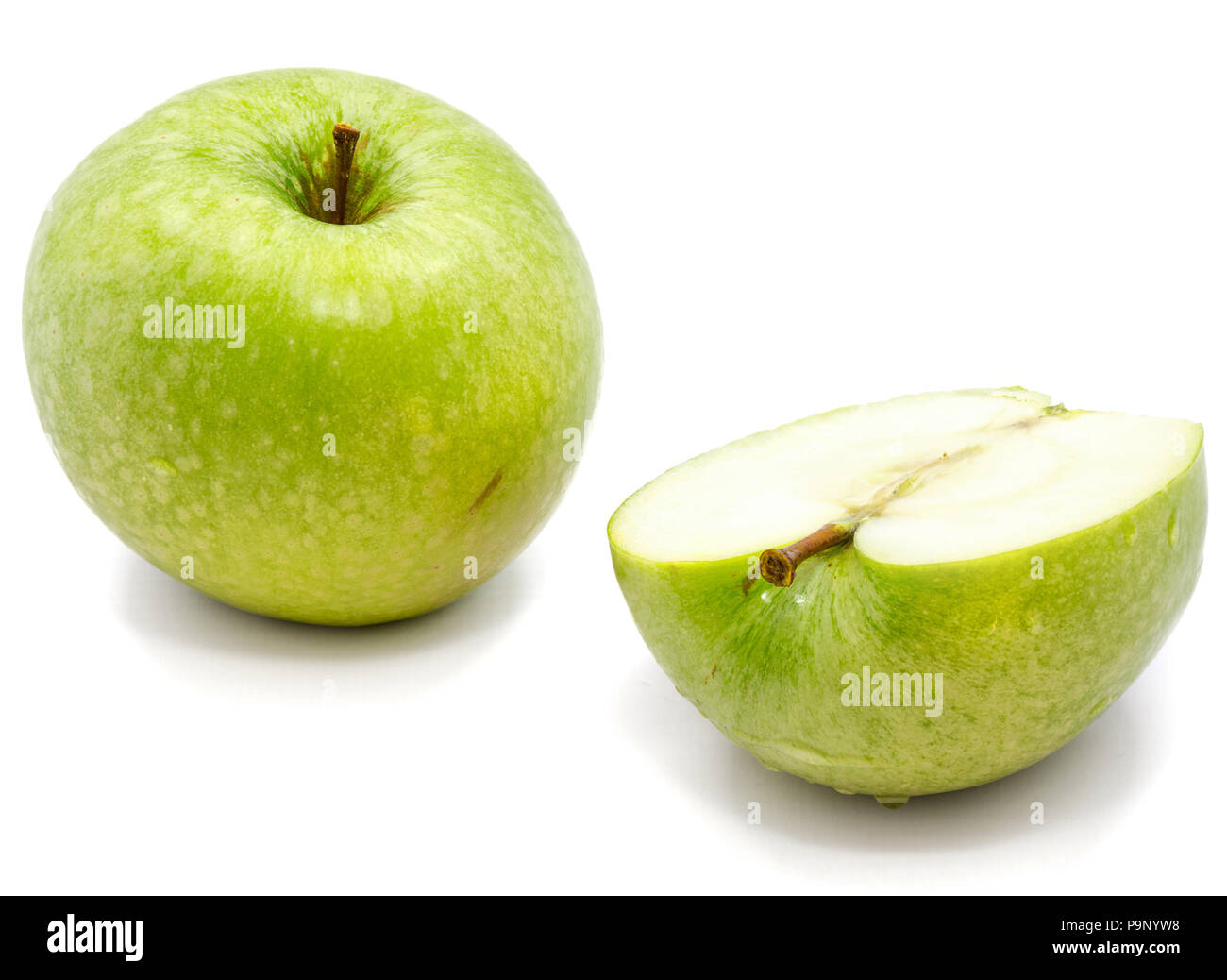 One whole apple Granny Smith and a half isolated on white background ...