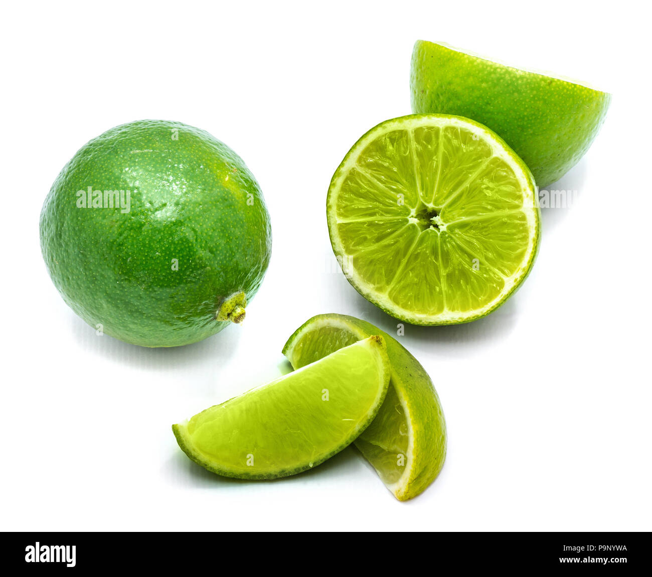 Group of whole, sliced lime and halves isolated on white background ...