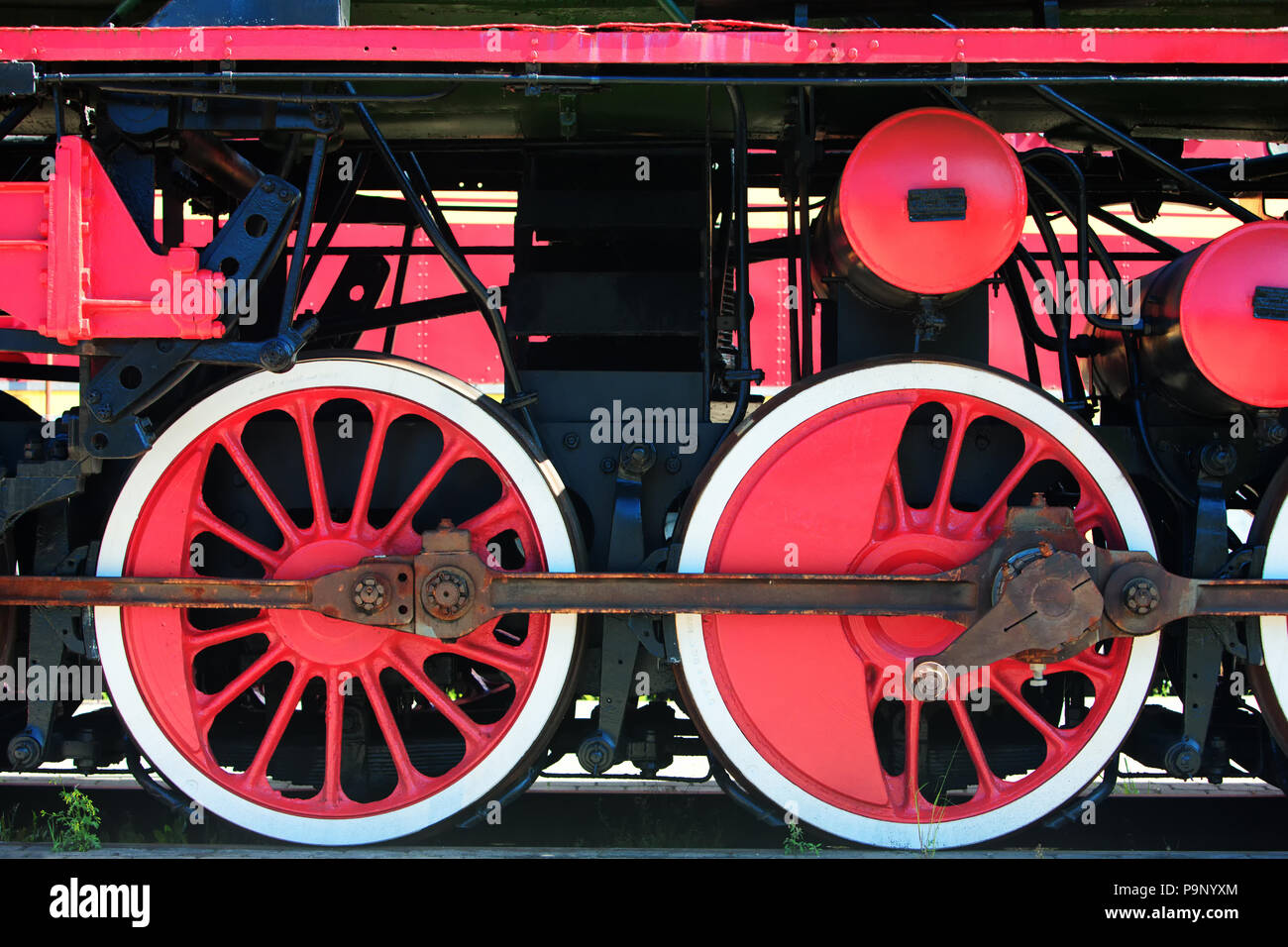 Vintage trains with large red wheels on the tracks on a sunny day Stock ...