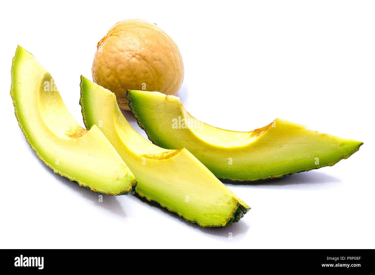 Avocado (Persea americana, alligator pear) slices with a stone isolated ...