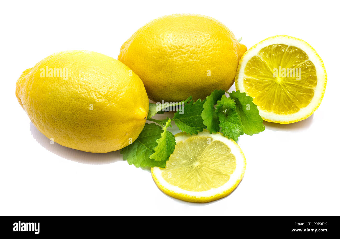 Two whole yellow lemons, cross section, slice and fresh green lemon ...