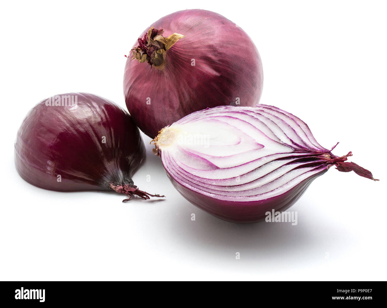 One whole red onion bulb and two halves isolated on white background ...