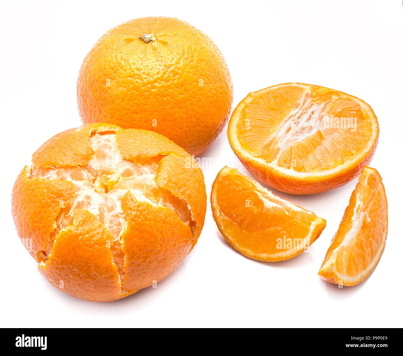 One whole and one peeled Clementine, one half and two slices isolated ...