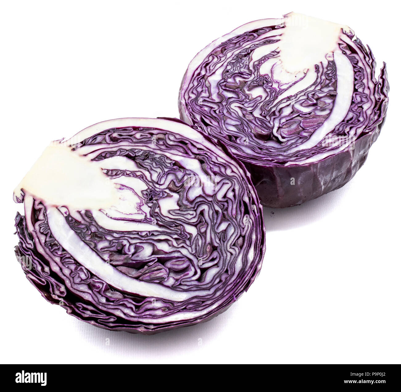 Two sliced halves of one whole purple cabbage isolated on white ...