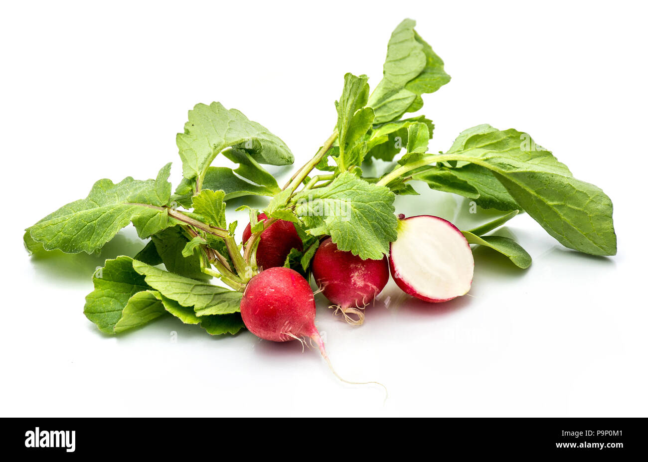 Group of whole and sliced red radish, one half, fresh green leaves ...