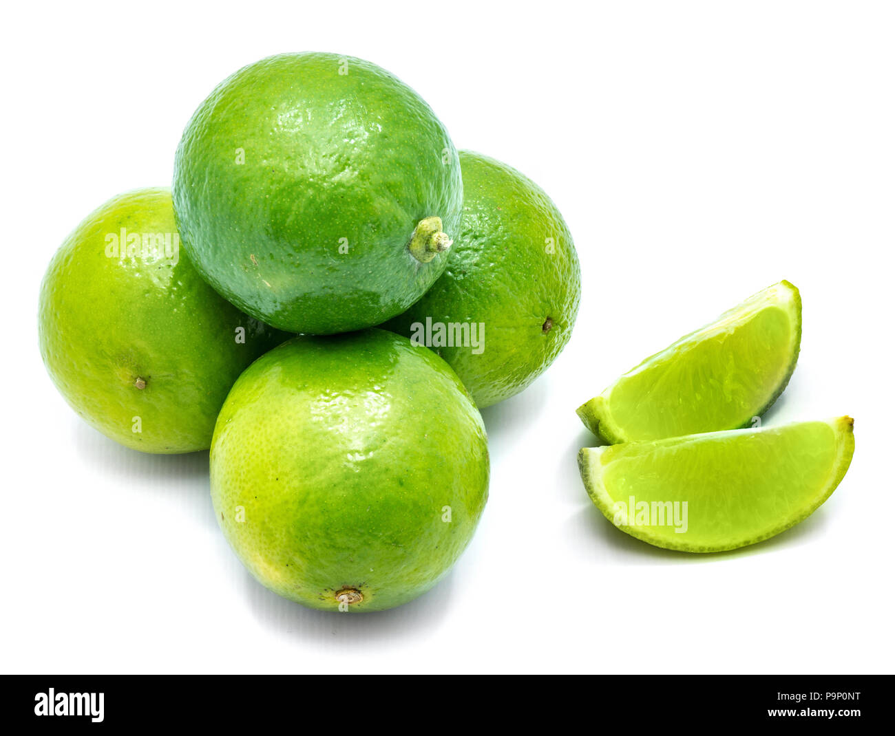 Group of whole green lime and two slices isolated on white background ...
