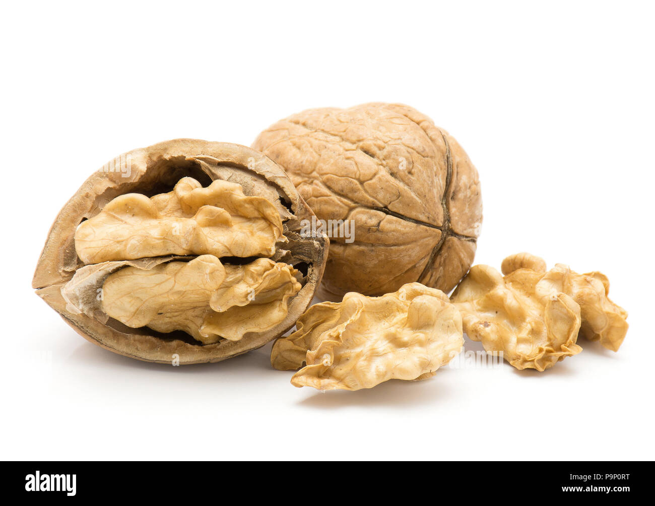 Walnuts isolated on white background one unshelled one open half and ...