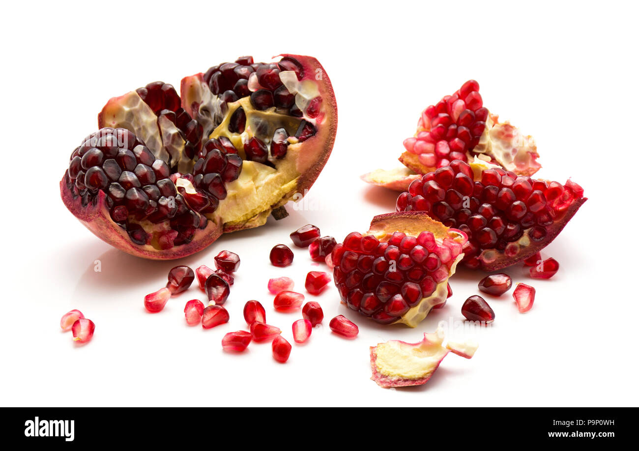 Split open pomegranate with revealed grains isolated on white ...