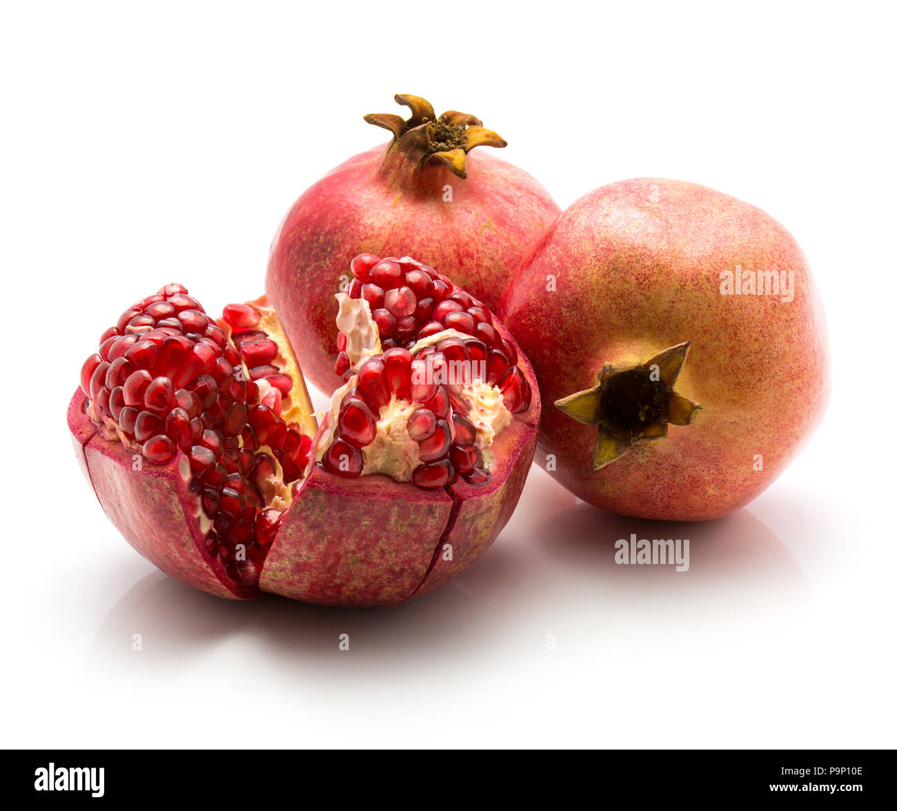 Pomegranate isolated on white background two whole one open Stock Photo ...