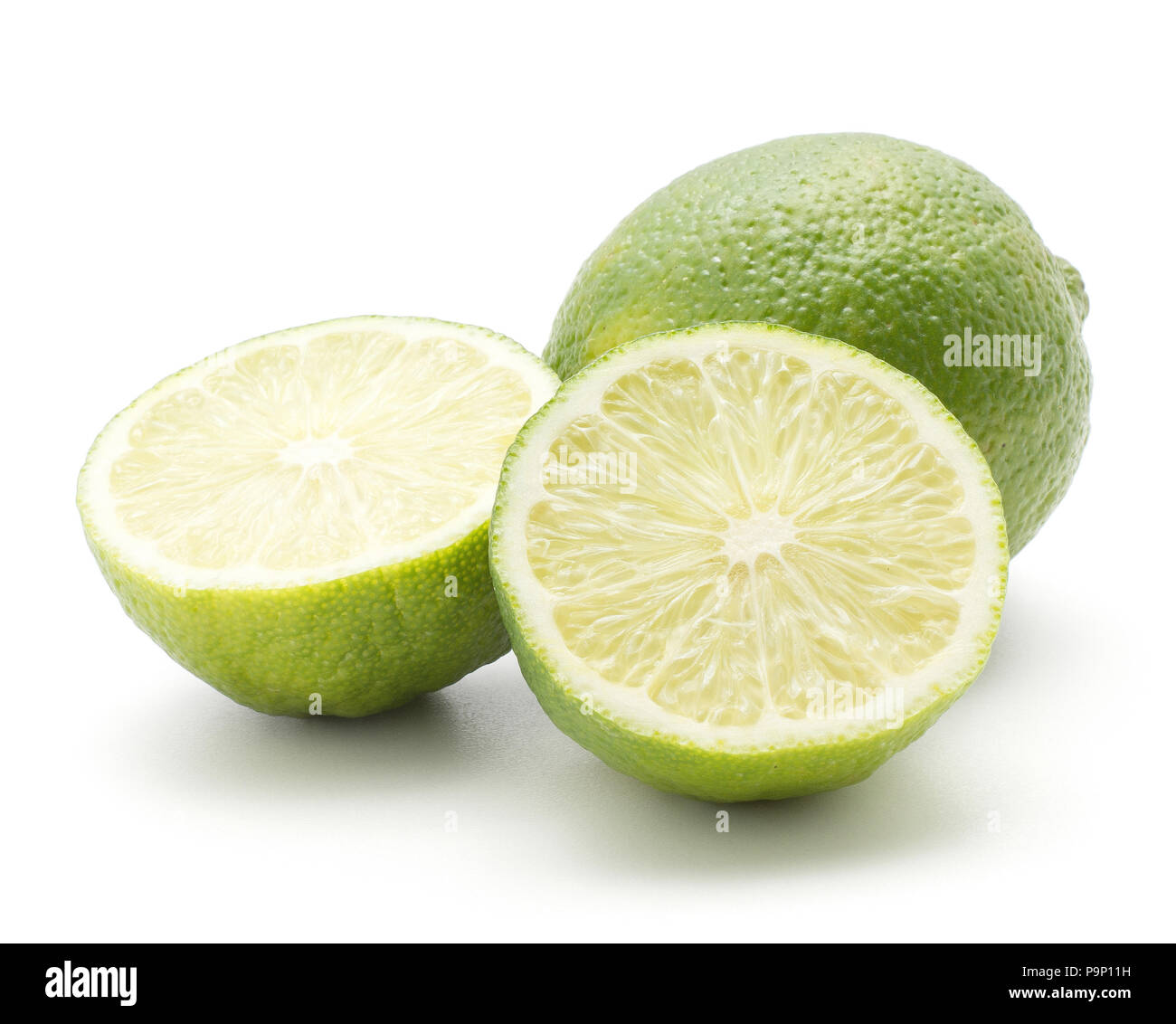 One lime and two halves isolated on white background Stock Photo - Alamy