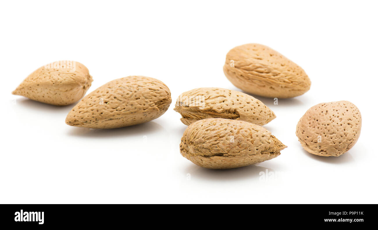 Unshelled almonds heap isolated on white background Stock Photo - Alamy