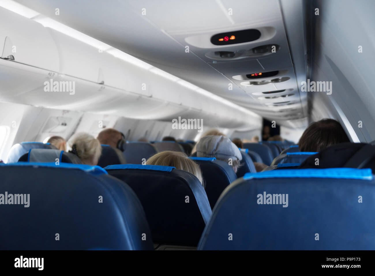 Interior inside of the plane with passengers Stock Photo - Alamy