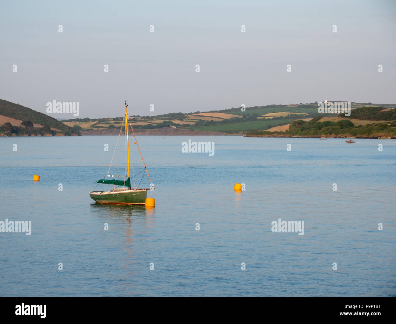 A small sailing boat moored in the River Camel estuary at Padstow ...