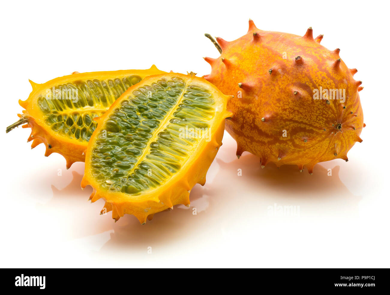 Kiwano isolated on white background one whole orange and three sliced ...