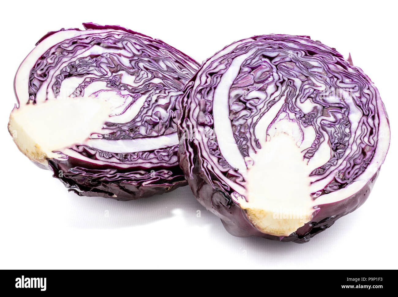 Two sliced halves of one whole purple cabbage isolated on white ...