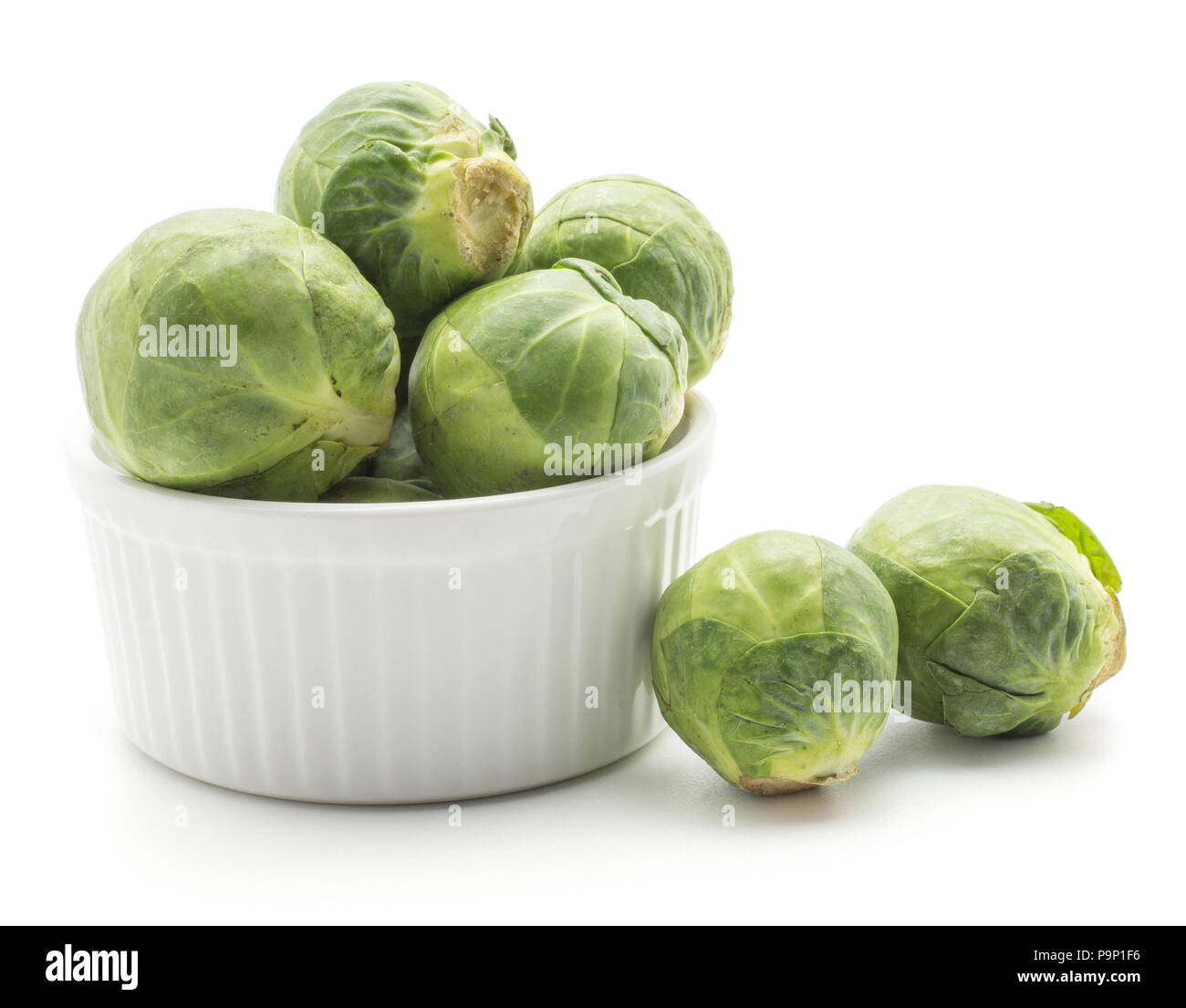 Brussels sprout heads in ceramic mold isolated on white background raw ...